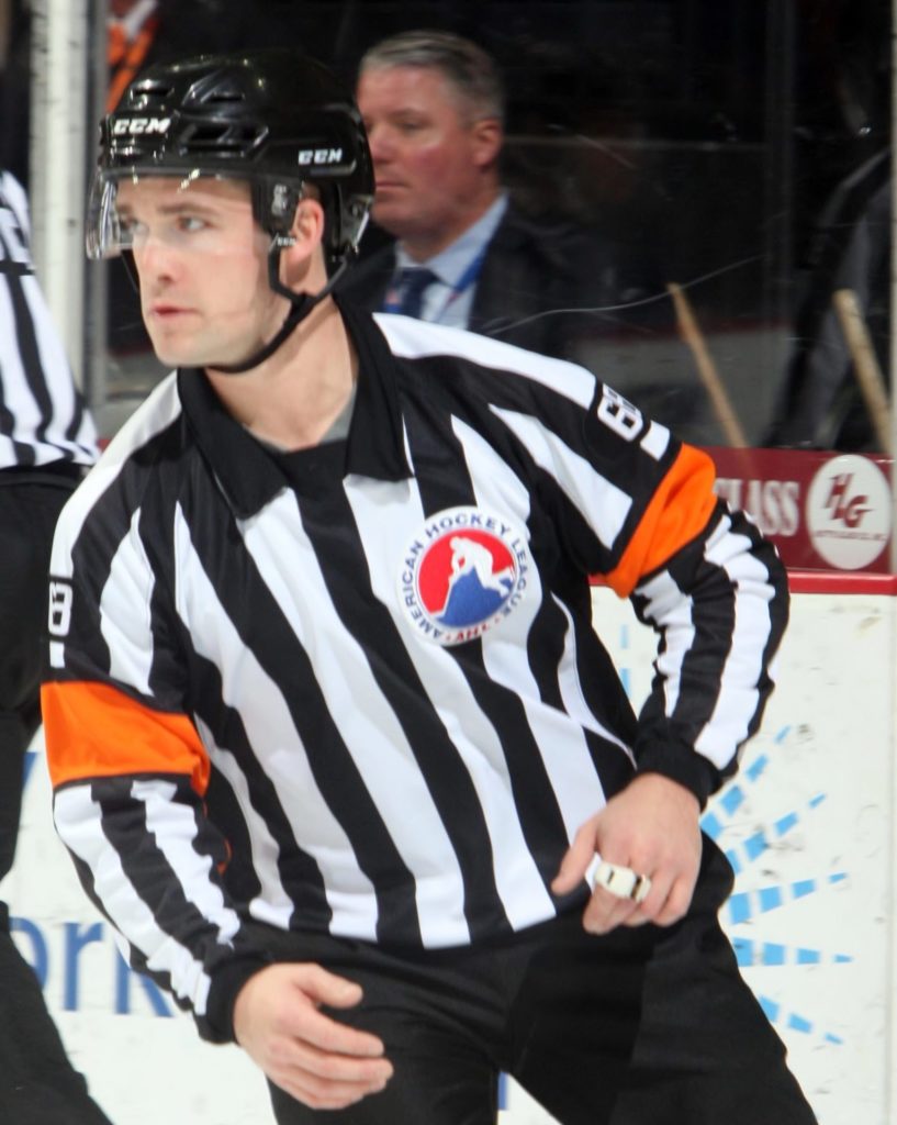 Grad a Law Enforcer on Ice and in Police Cruiser